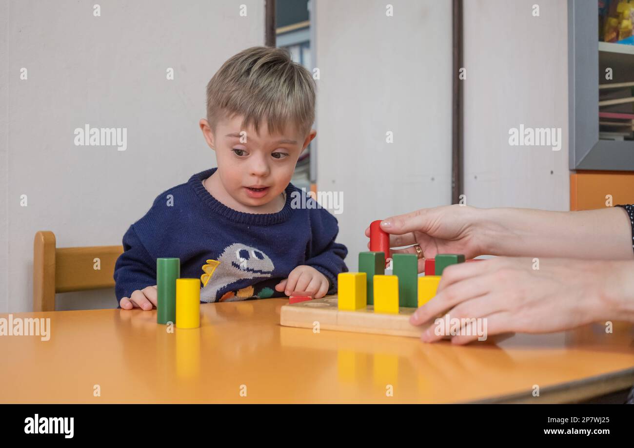 boy with Down Syndrome enjoying playtime with toys at the ...
