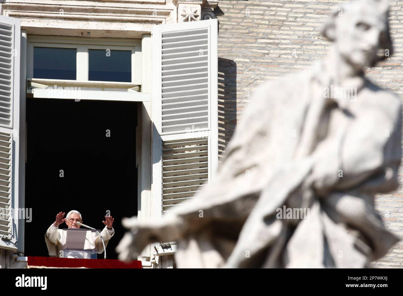 Pope Benedict XVI waves at faithful during the Angelus prayer on All ...