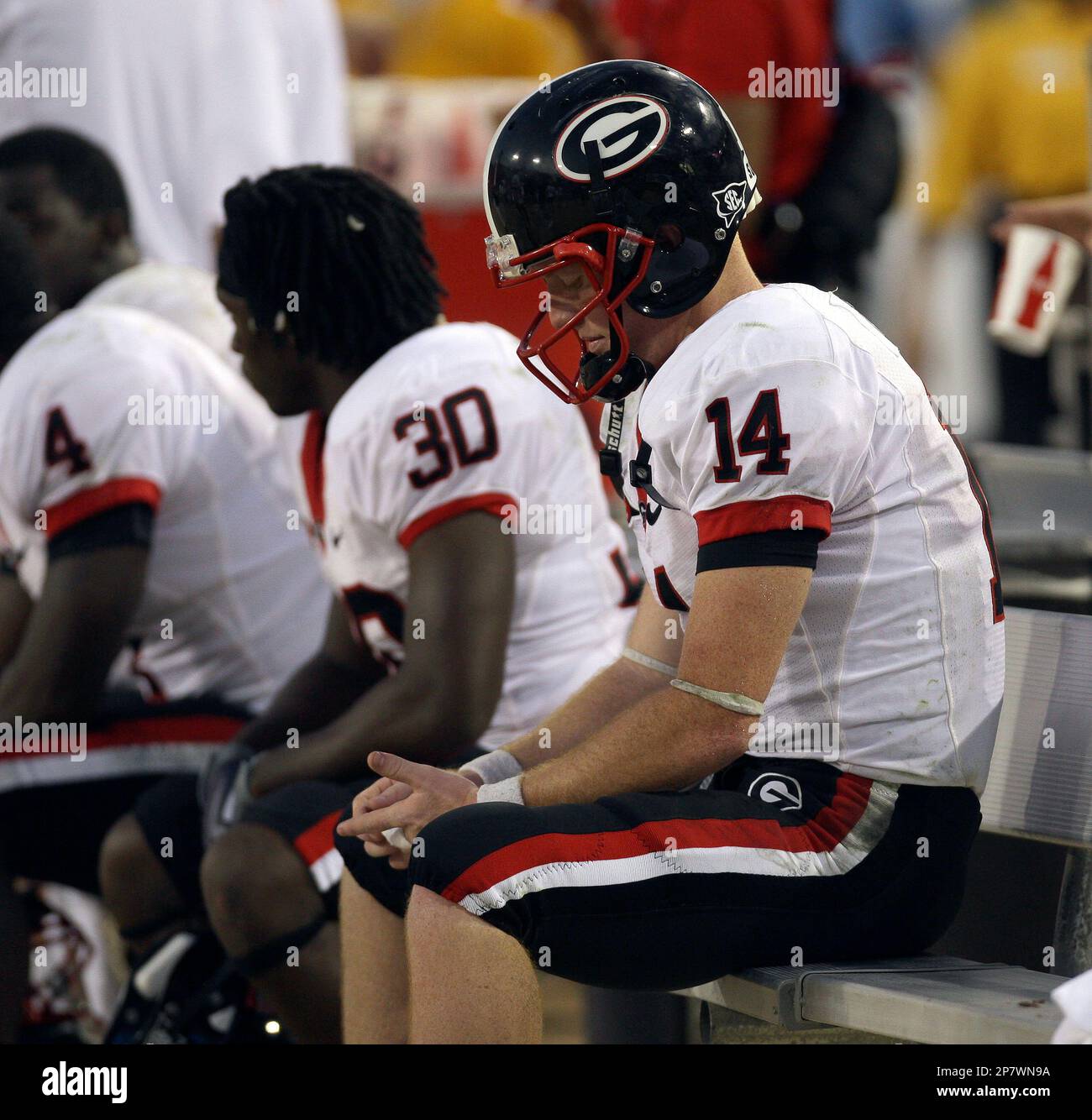 Georgia quarterback Joe Cox, right, shows his dejection as he sits on ...