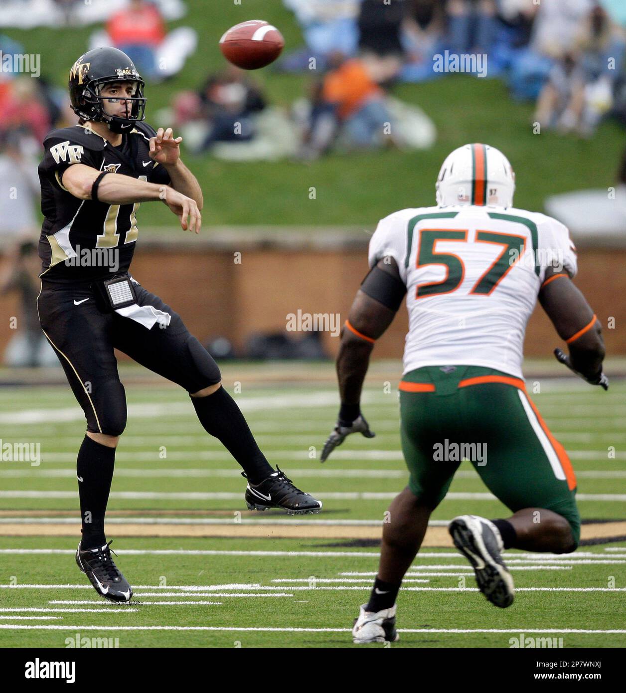 Wake Forest's Riley Skinner (11) throws a pass as he is pressured by ...