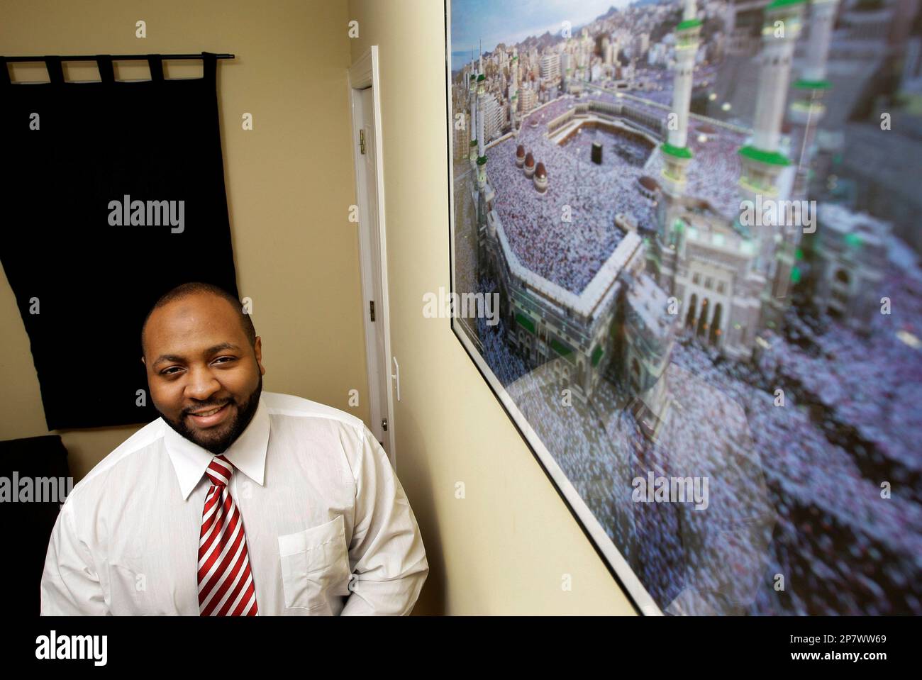 Sekou Jackson poses next to a picture of Mecca, Friday, Oct. 30, 2009 ...
