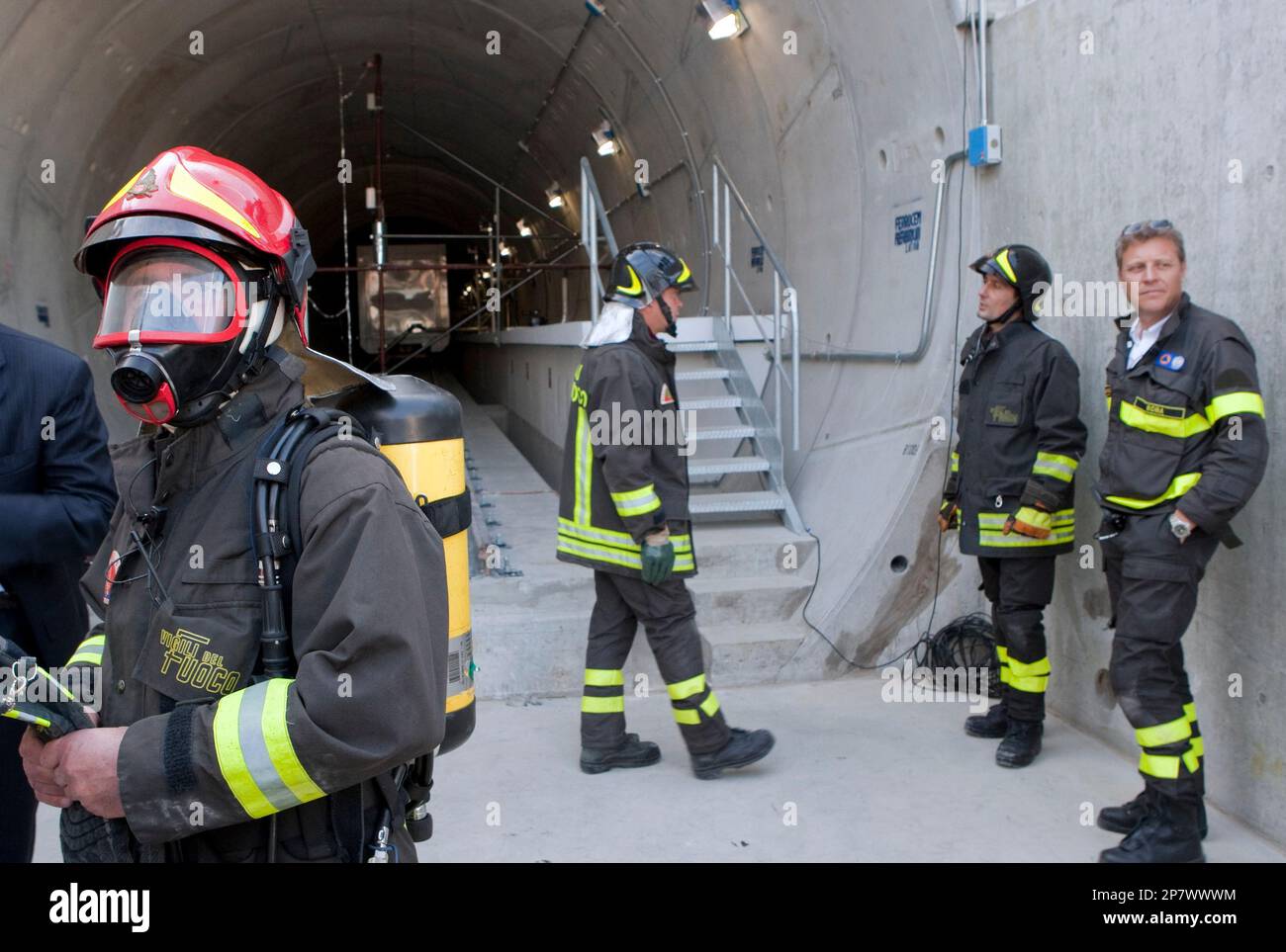 Firefighters look on as they simulate a fire on a real size model of an ...