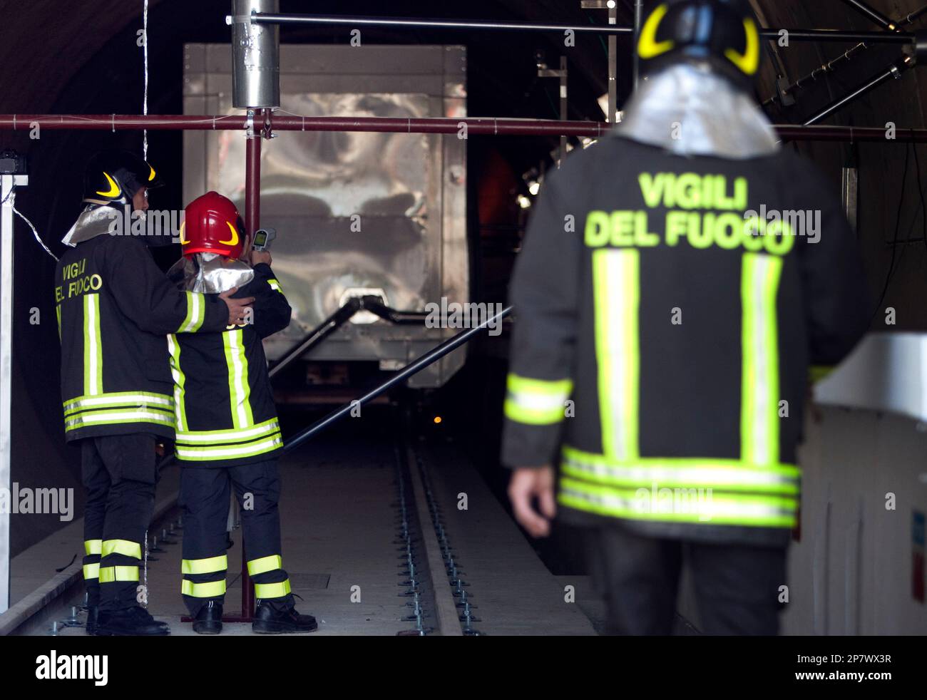 Firefighters measure the temperature as they simulate a fire on a real ...