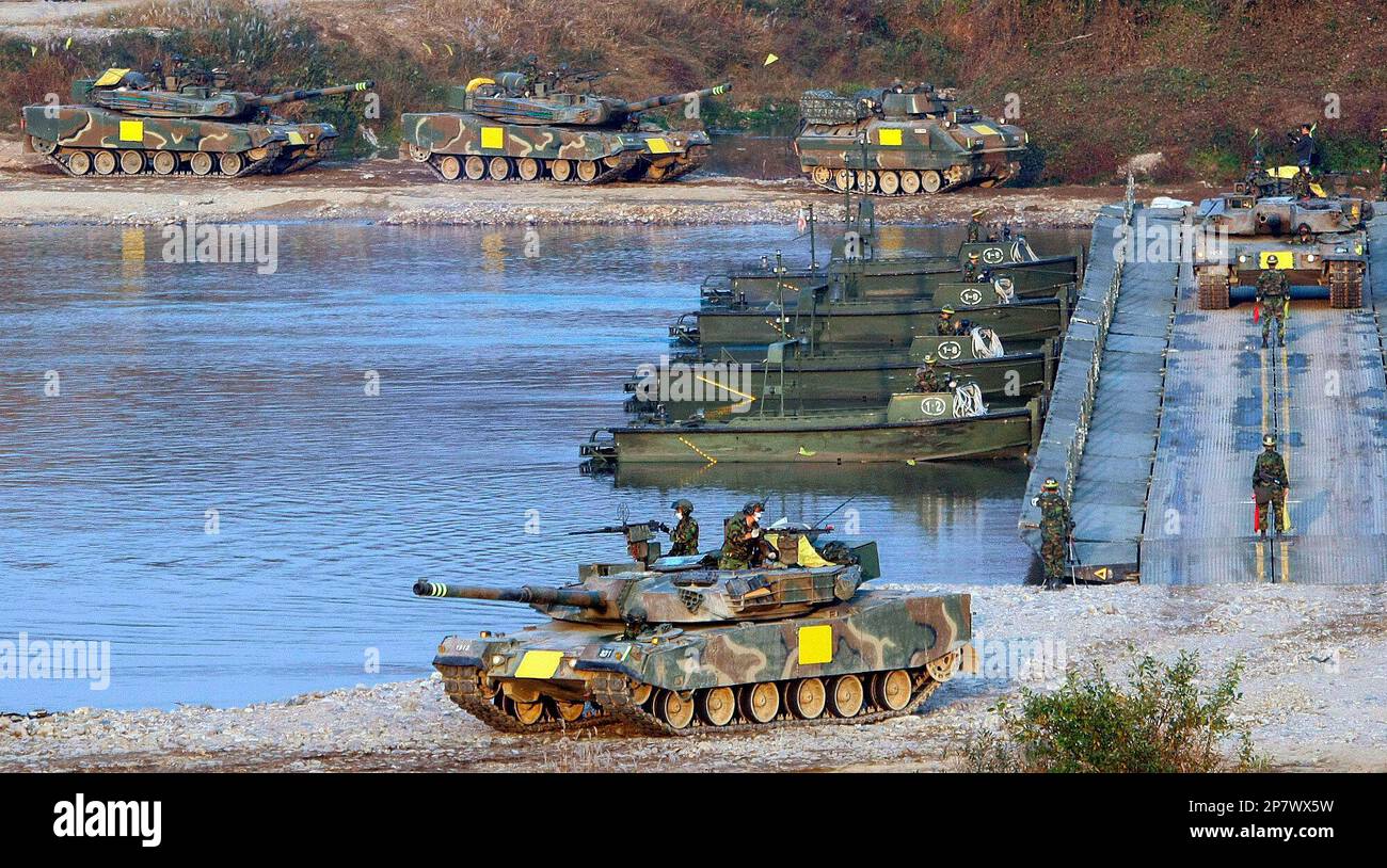 South Korean army tanks and armored vehicles cross a river during a ...
