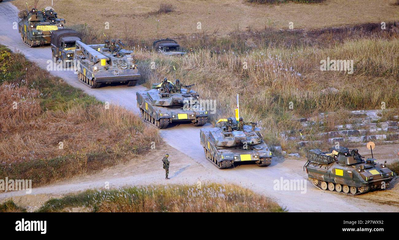 South Korean army tanks and armored vehicles prepare to cross a river ...