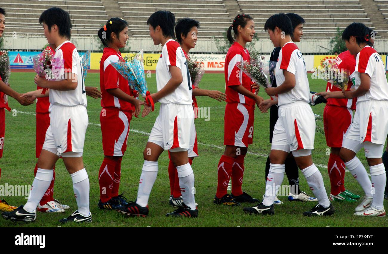 Players of North Korea's Under 16 women's team, white, shake hands with ... Players of North Korea's Under 16 women's team, white, shake hands with ...