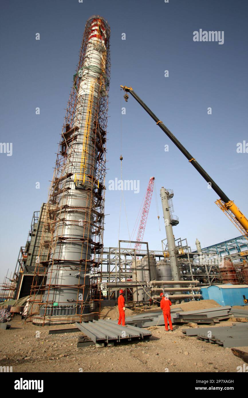 Workers labour at the fertilizer plant of PetroChina Tarim Oilfield ...