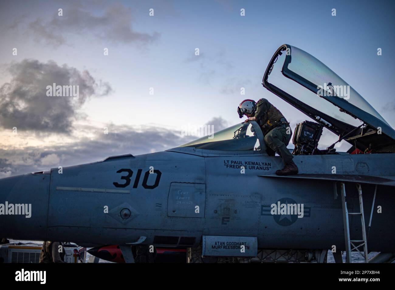 230307-N-XK462-1056 PHILIPPINE SEA (March 7, 2023) A U.S. Navy Sailor climbs into an F/A-18E ...