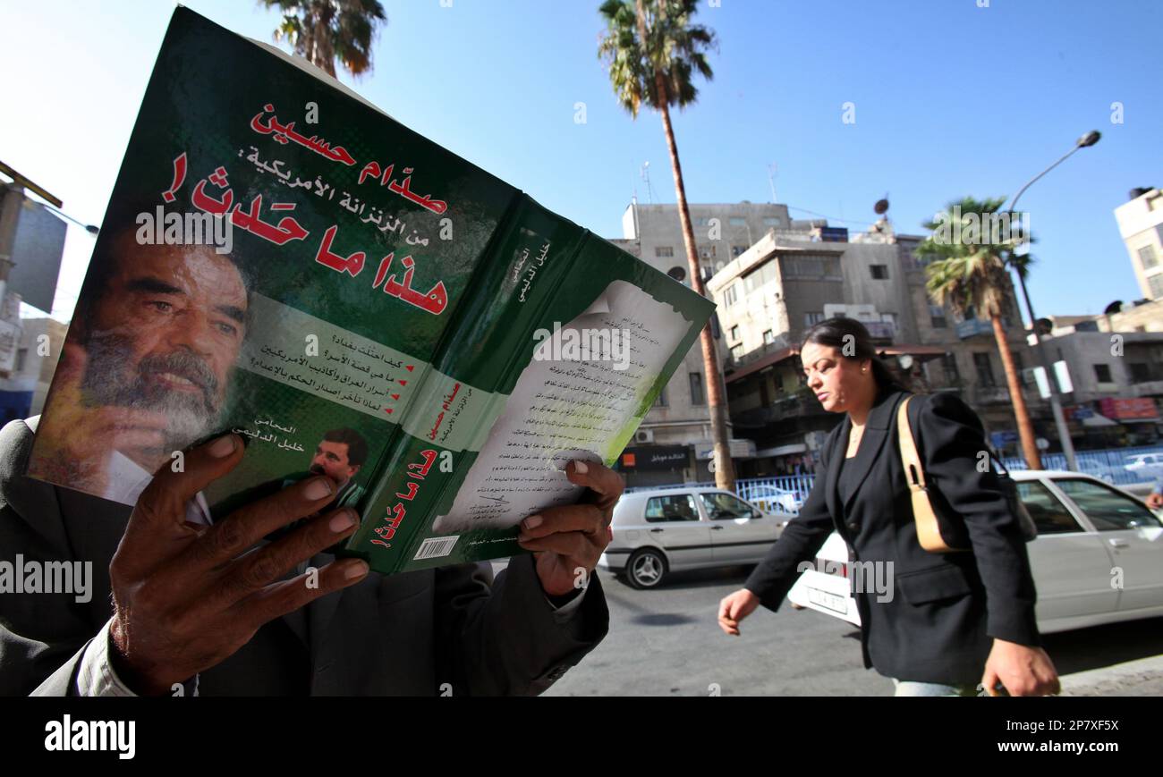 A man looks at a copy of the book "Al Ra'ees Al Shaheed" (The Martyred ...