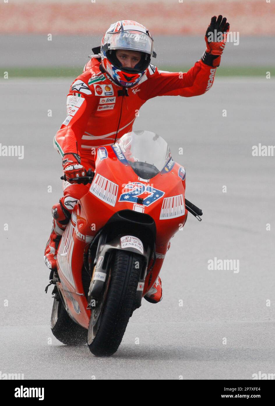 Australia's Casey Stoner waves to the crowd after winning the Malaysian ...
