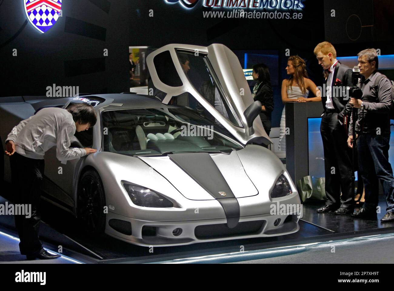 Visitors examine a luxury car at the Millionaire Fair in Moscow ...