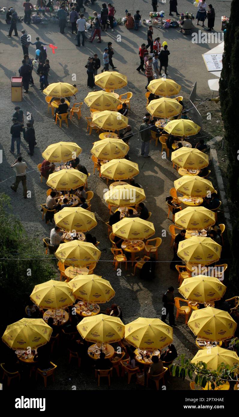 People sit in an open-air cafe during celebrations of the annual ...