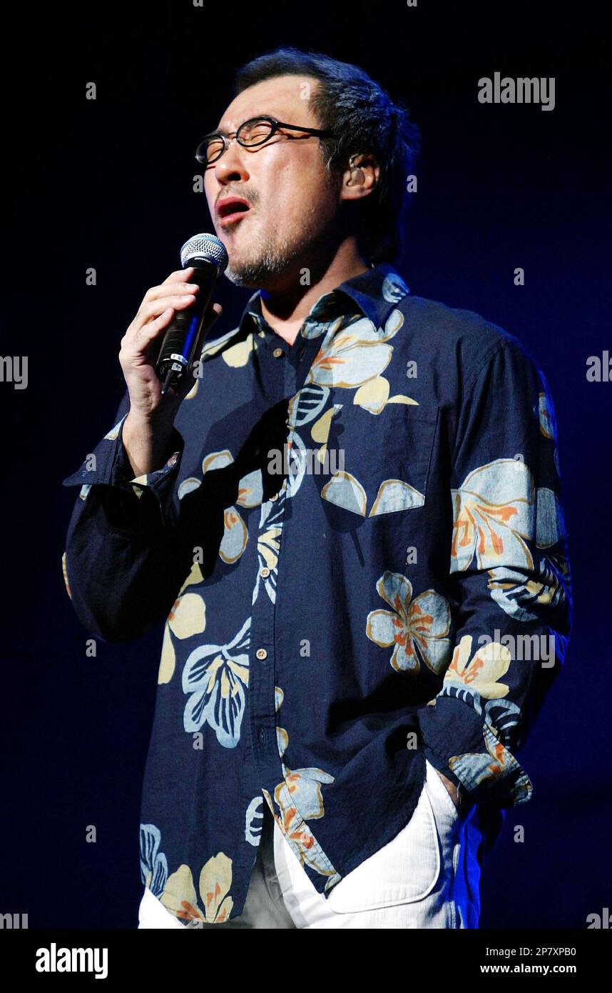 Taiwan singer Jonathan Lee sings during his concert at the Great Hall ...