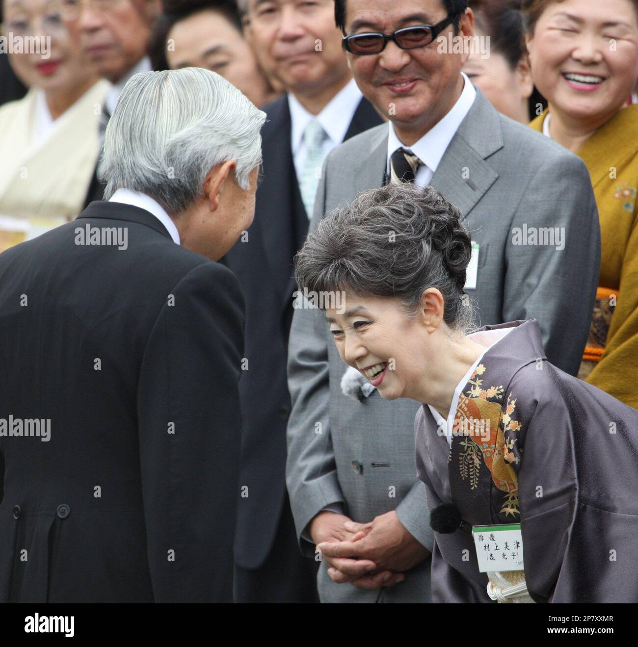 Japan's Emperor Akihito, left, greets Japanese actress Mitsuko Mori ...