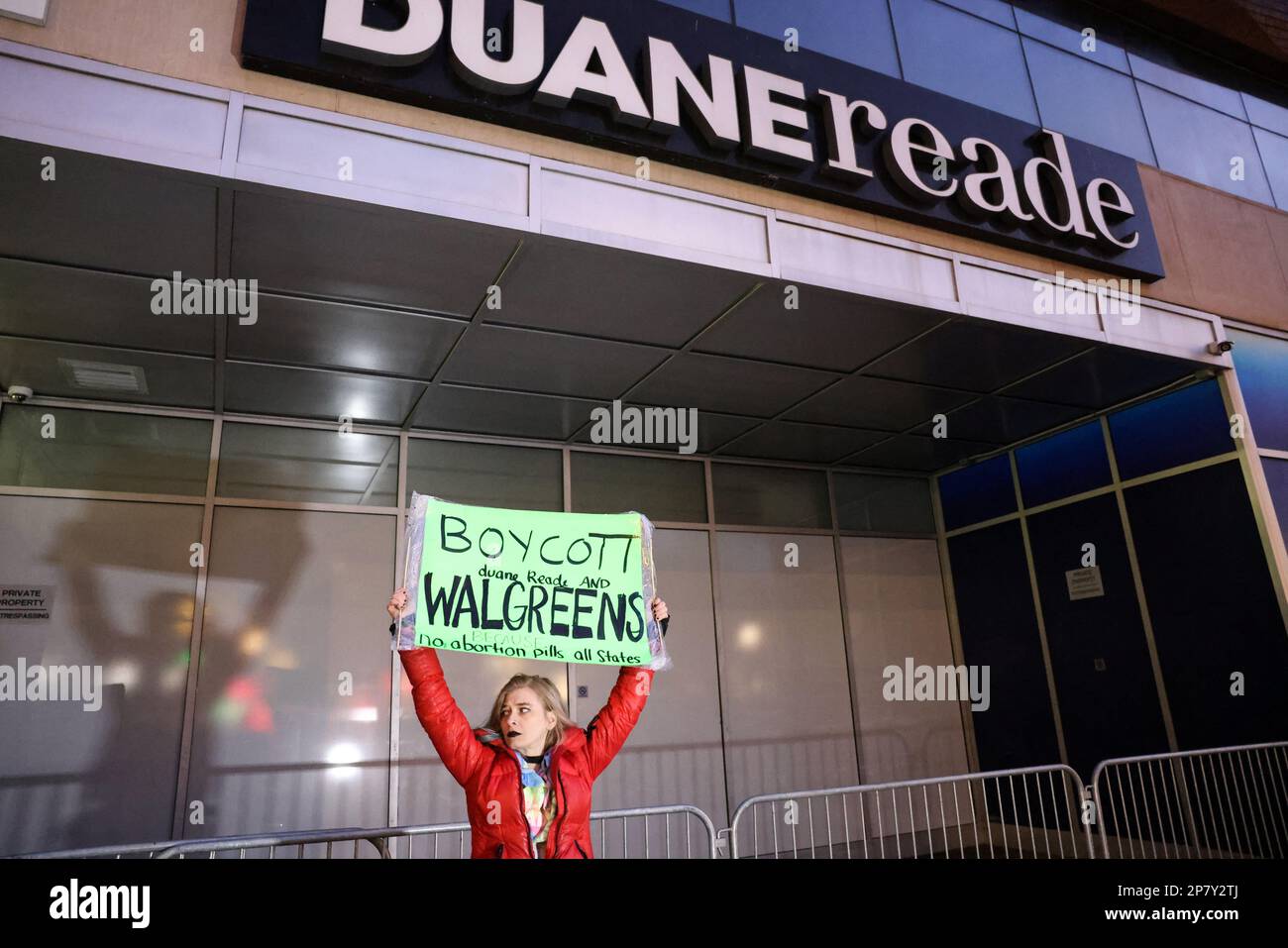 A woman protests outside Duane Reade in support of women's reproductive ...