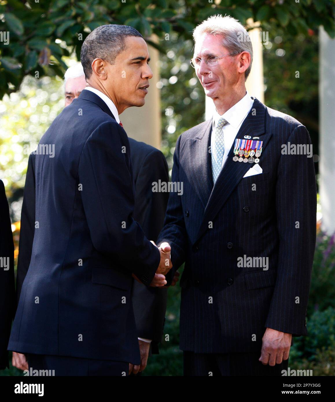 President Barack Obama shakes hands with Capt. John Poindexter in the ...