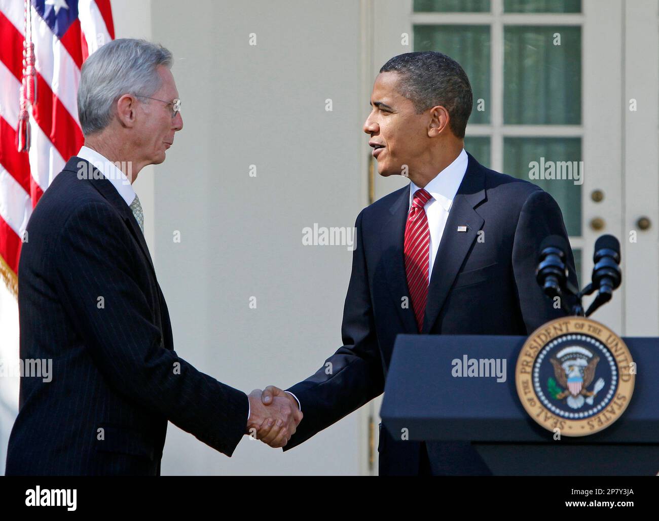 President Barack Obama shakes hands with retired Army Capt. John ...