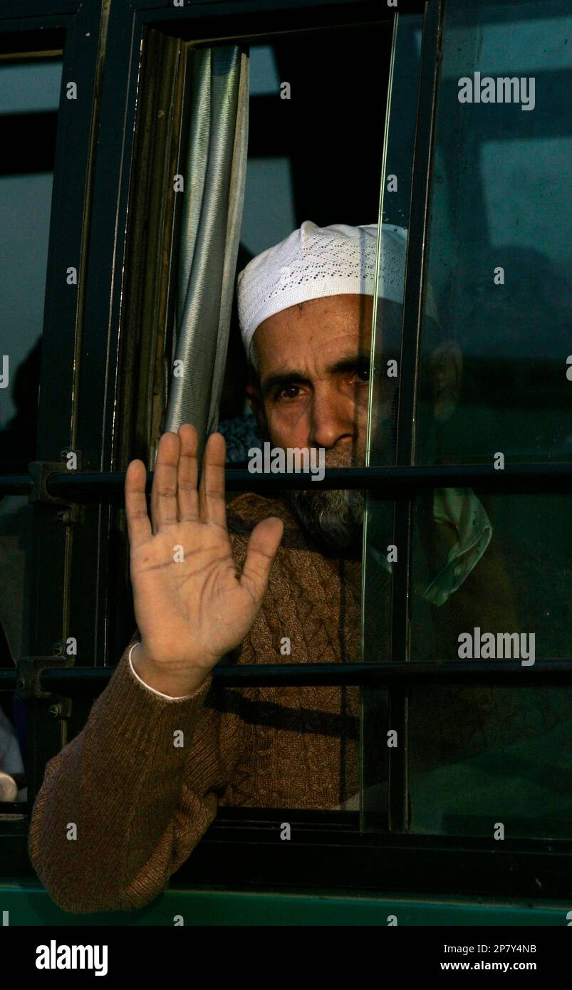 A Kashmiri Muslim pilgrim, waves from a window of a bus in Srinagar ...