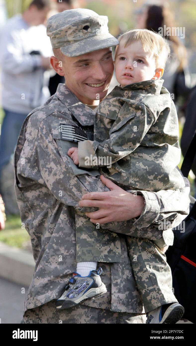 Spc. Brian Abbott Sr., smiles as he embraces his son Brian Jr. as ...