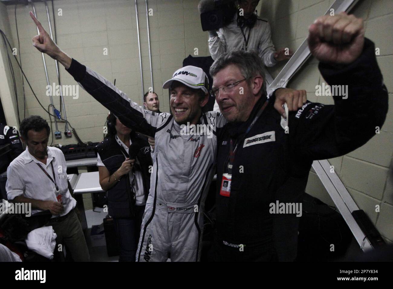 Brawn GP's driver Jenson Button, of Britain, left, celebrates with his ...