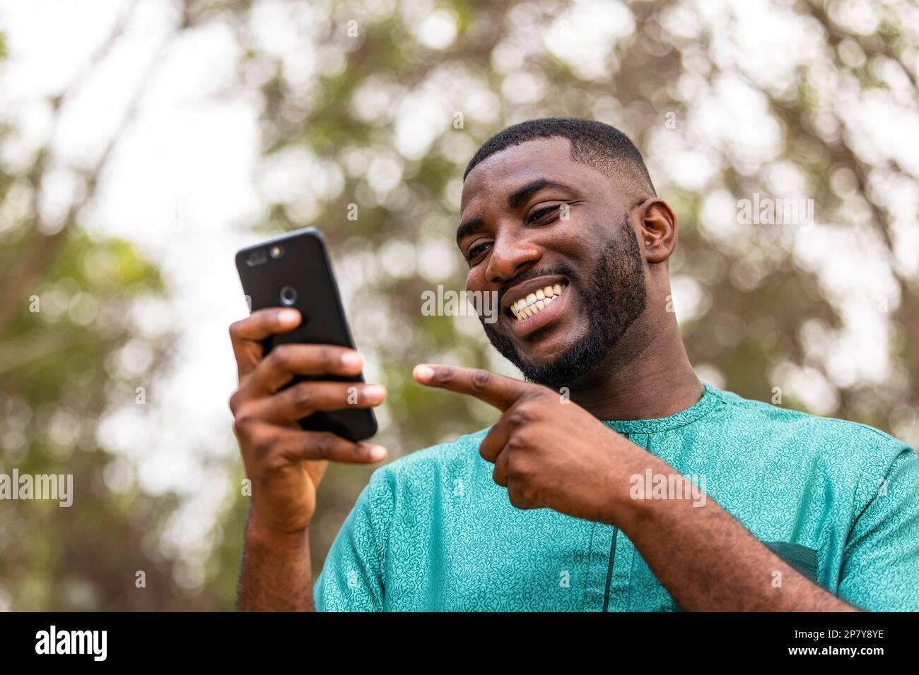 African man using smartphone to stay connected, Socializing with ...