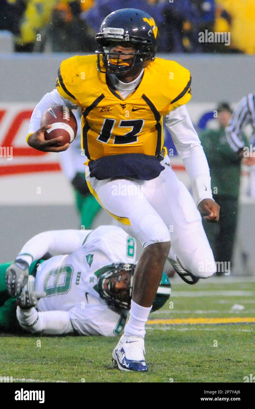 West Virginia quarterback Geno Smith carries the ball as Marshall's ...