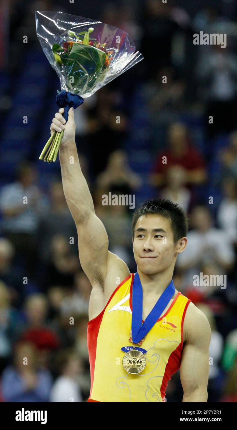 Gold medalist Yan Mingyong of China waves during the ceremony for the ...