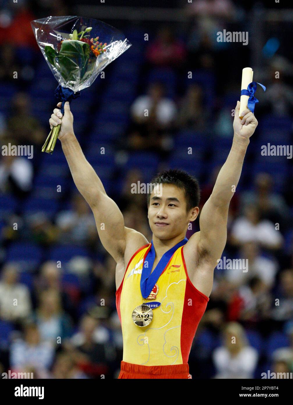 Gold medalist Yan Mingyong of China waves during the ceremony for the ...