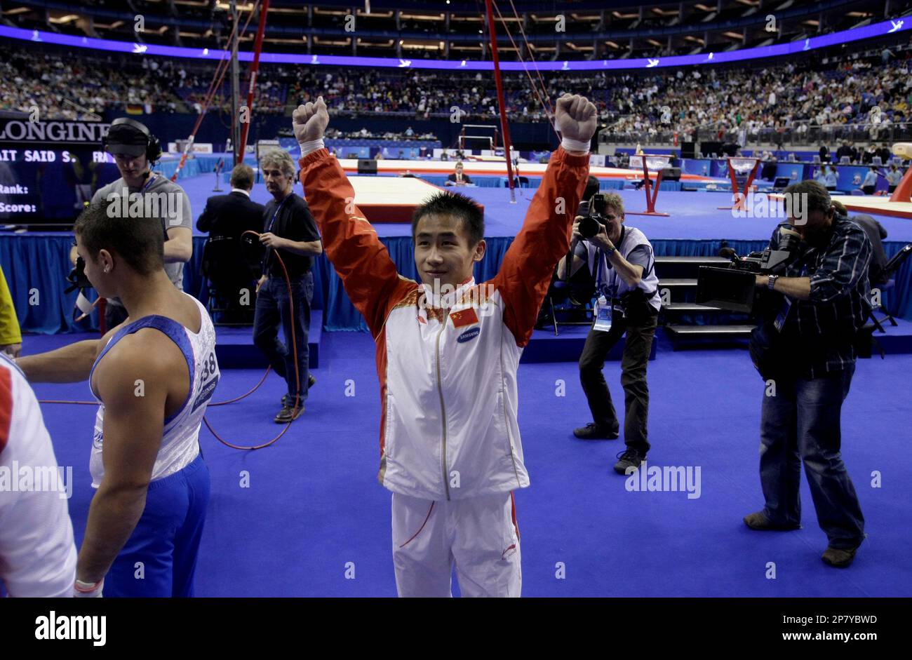 China's Yan Mingyong celebrates after winning gold in the men's rings ...