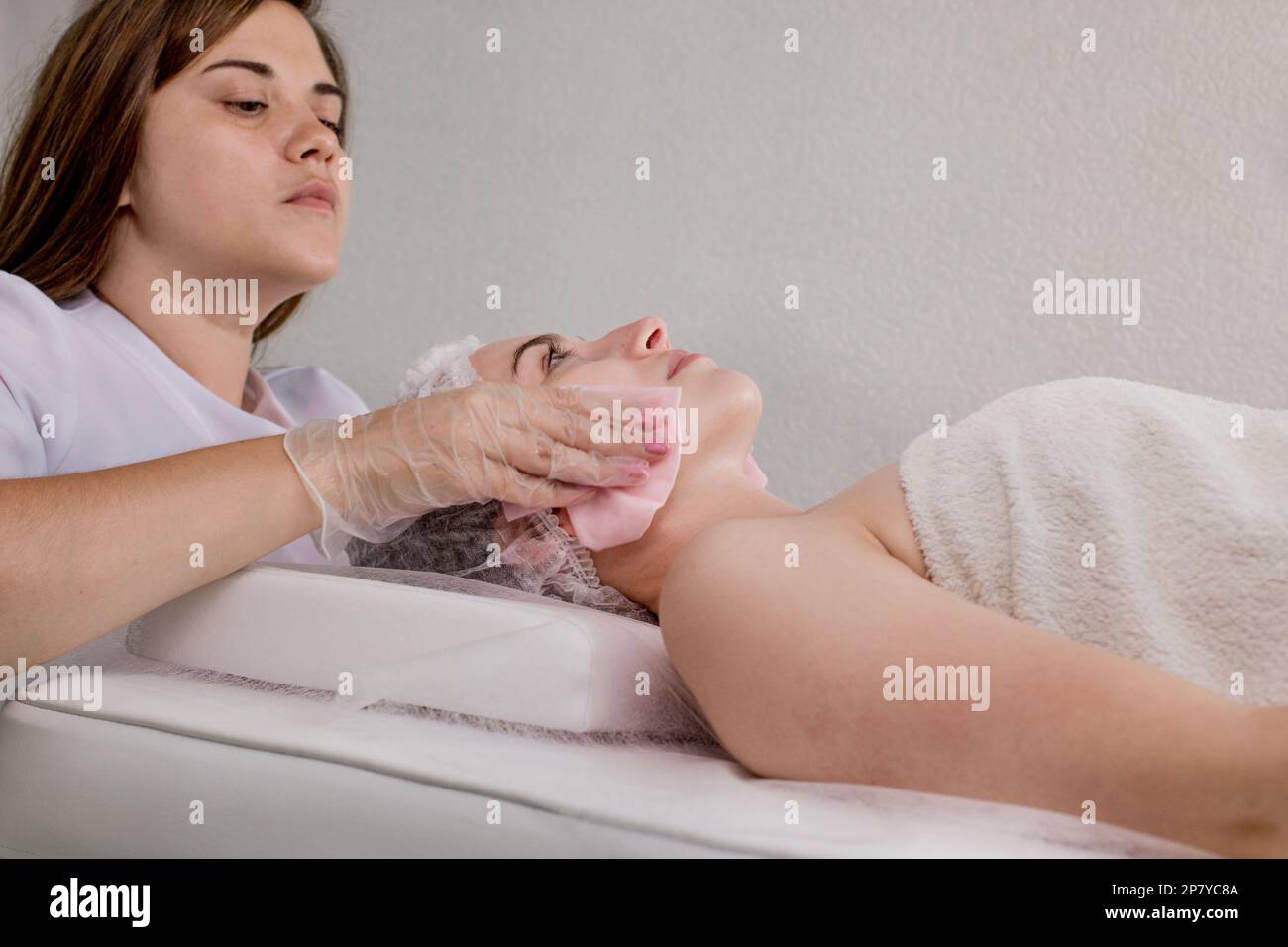 Professional beautician wipes woman face hi-res stock photography and ...