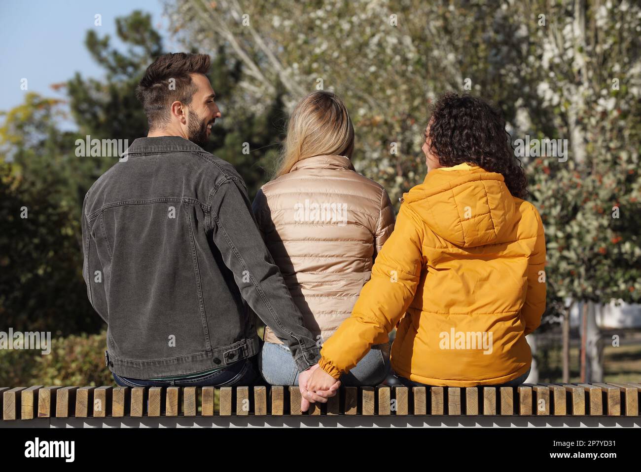 Man holding hands with another woman behind his girlfriend's back on ...