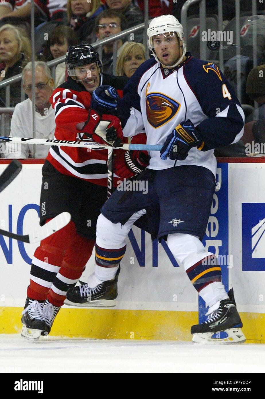 New Jersey Devils' Jay Pandolfo (20) is held back by Atlanta Thrashers ...