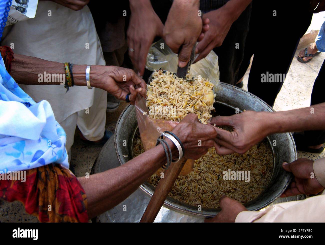 Pakistani poor people receive free food in Karachi, Pakistan, on the ...