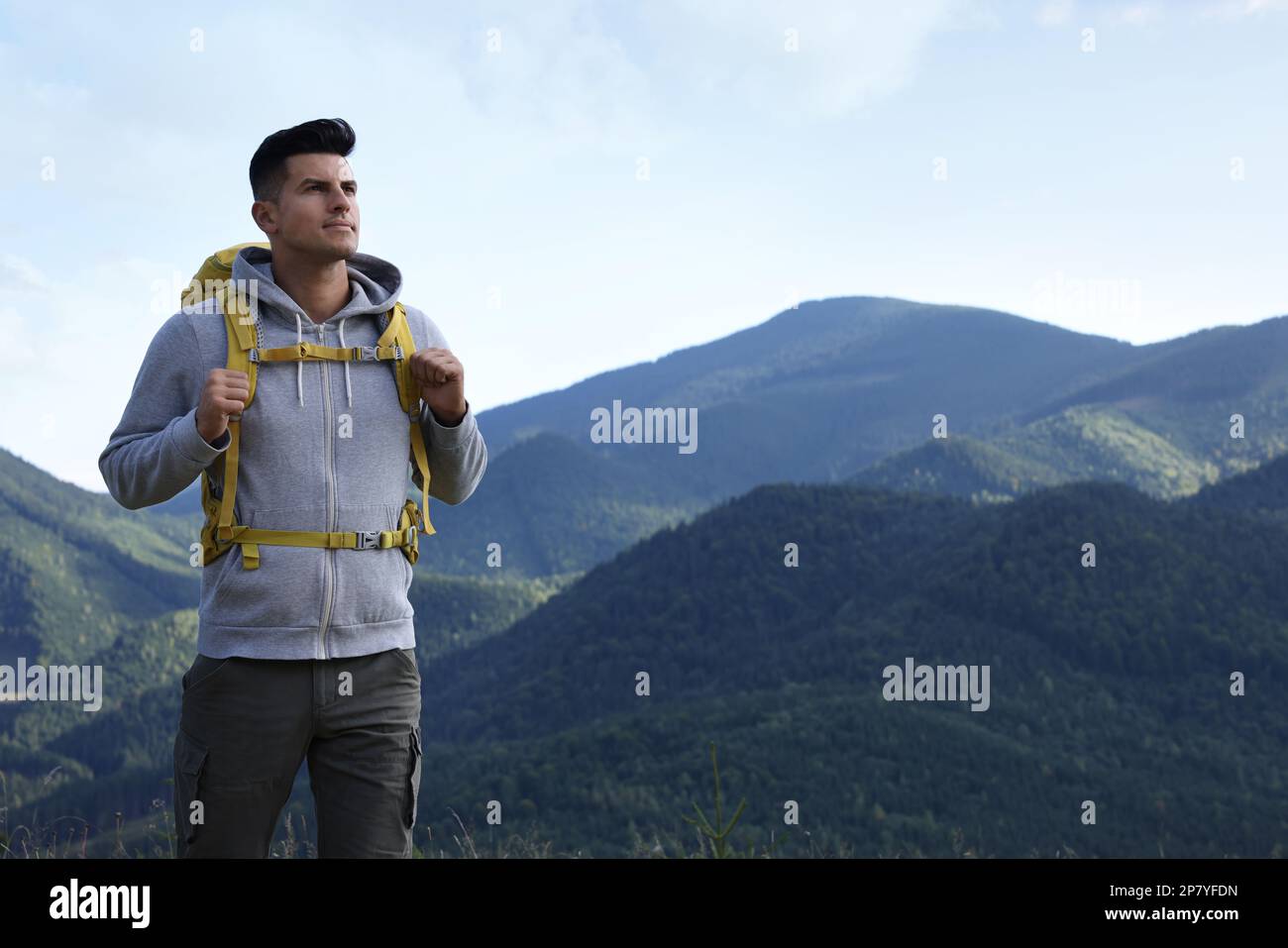 Tourist with backpack in mountains, space for text Stock Photo - Alamy