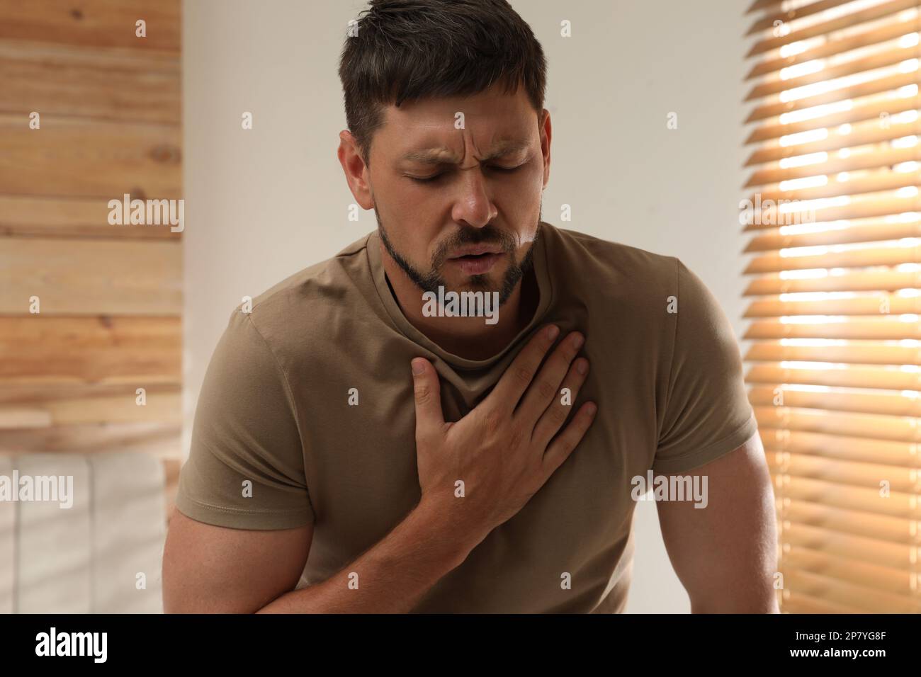 Man suffering from pain during breathing at home Stock Photo - Alamy