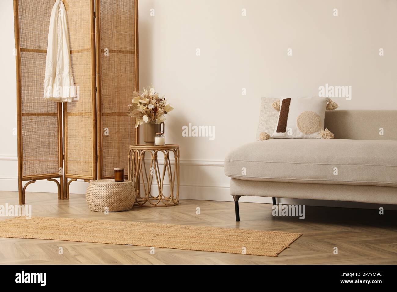 Stylish living room with folding screen and sofa. Interior design Stock ...