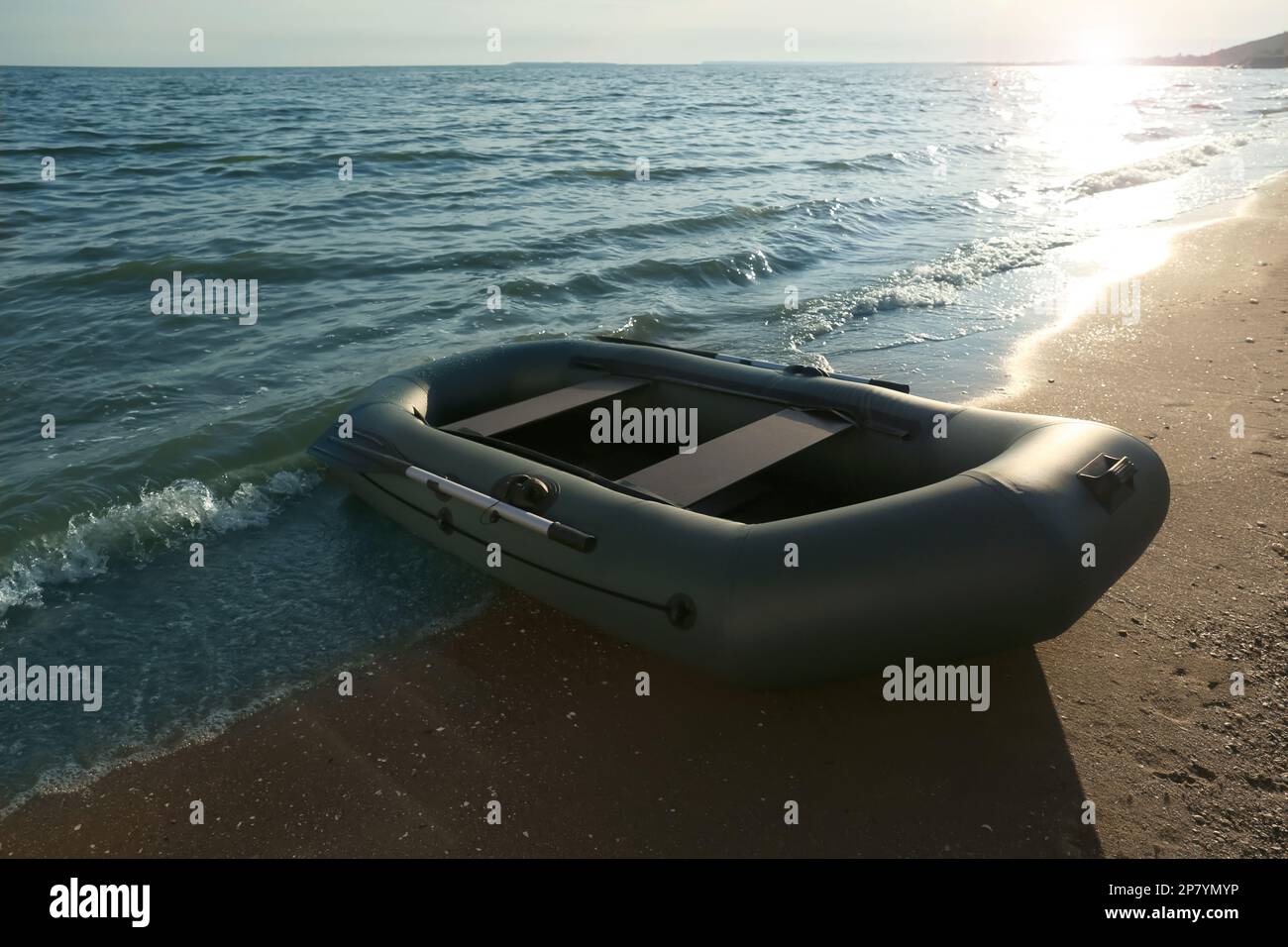 Inflatable rubber fishing boat on sandy beach near sea Stock Photo - Alamy