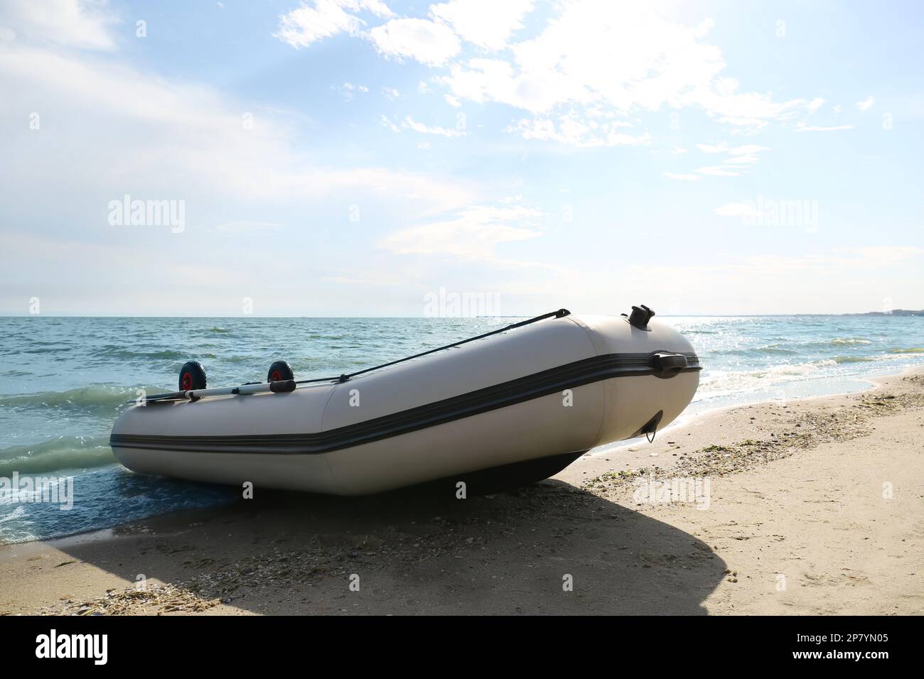 Inflatable rubber fishing boat on sandy beach near sea Stock Photo - Alamy