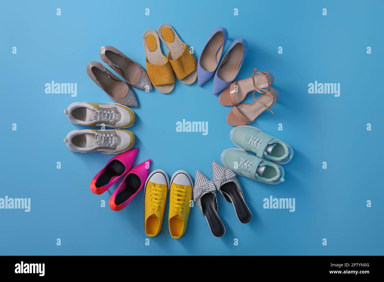 Different shoes on turquoise background, flat lay with space for text ...