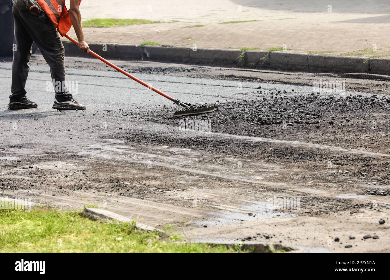 Worker leveling new pavement hi-res stock photography and images - Alamy