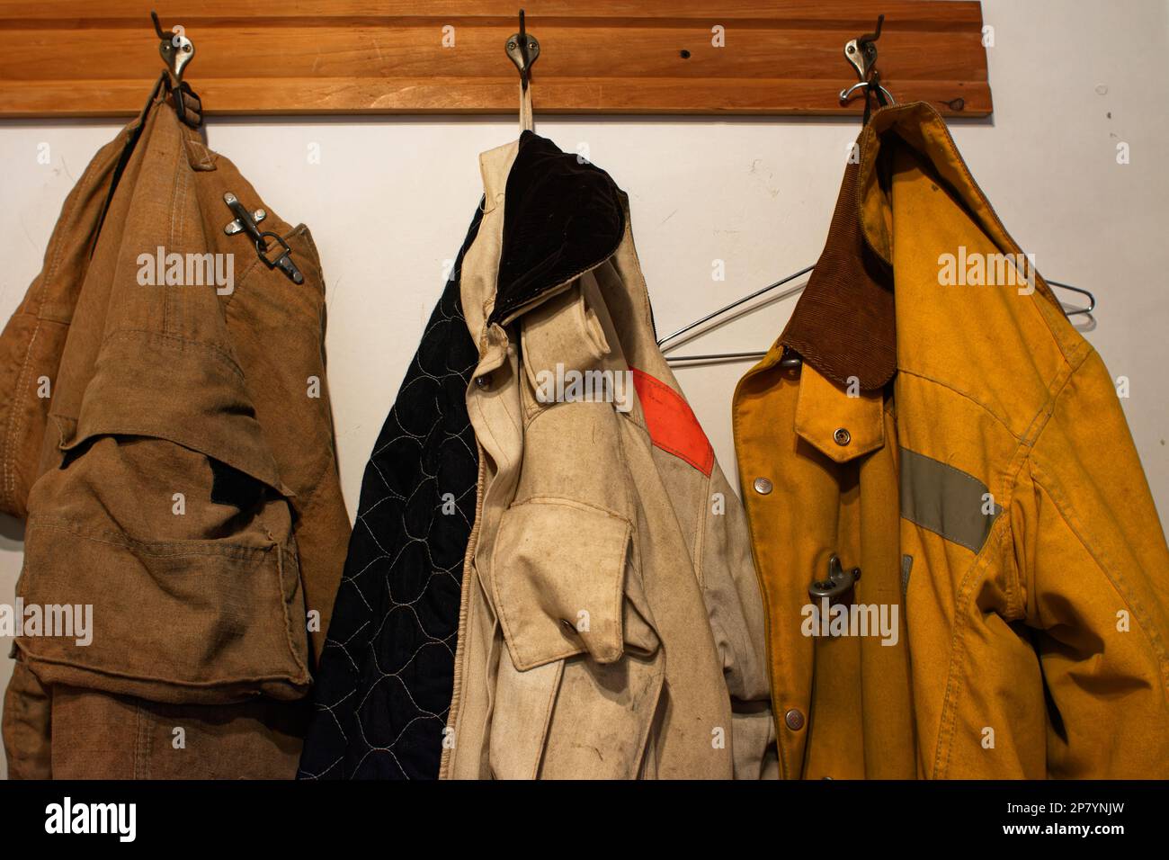 Three seasoned fireman coats hang on a wall in the Seacoast Fire Museum ...