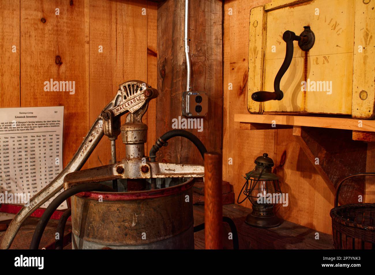 An aged and weathered metal hand water pump is displayed in the ...