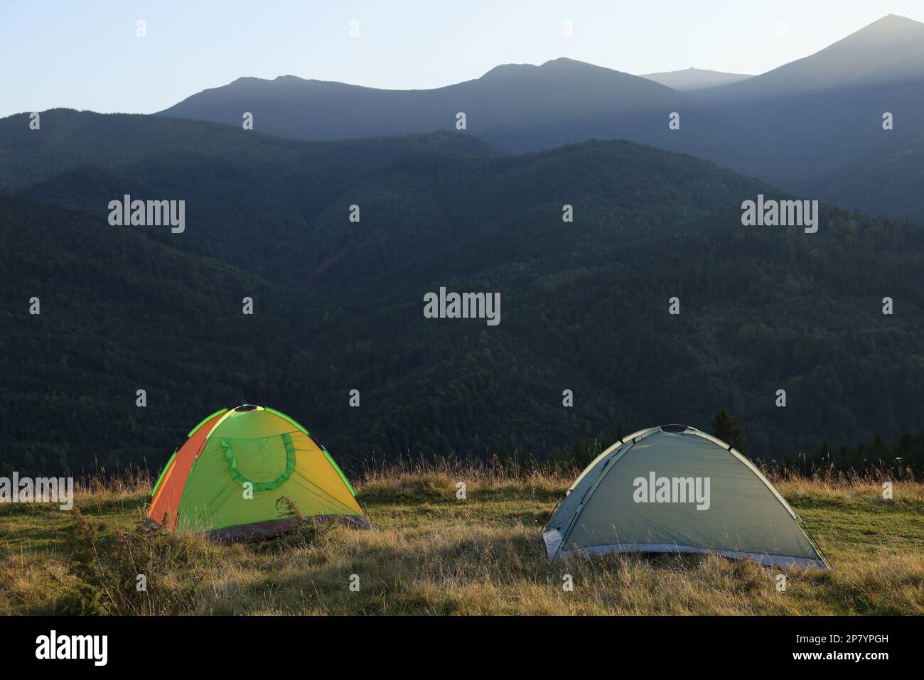 Two color camping tents on hill in mountains Stock Photo - Alamy