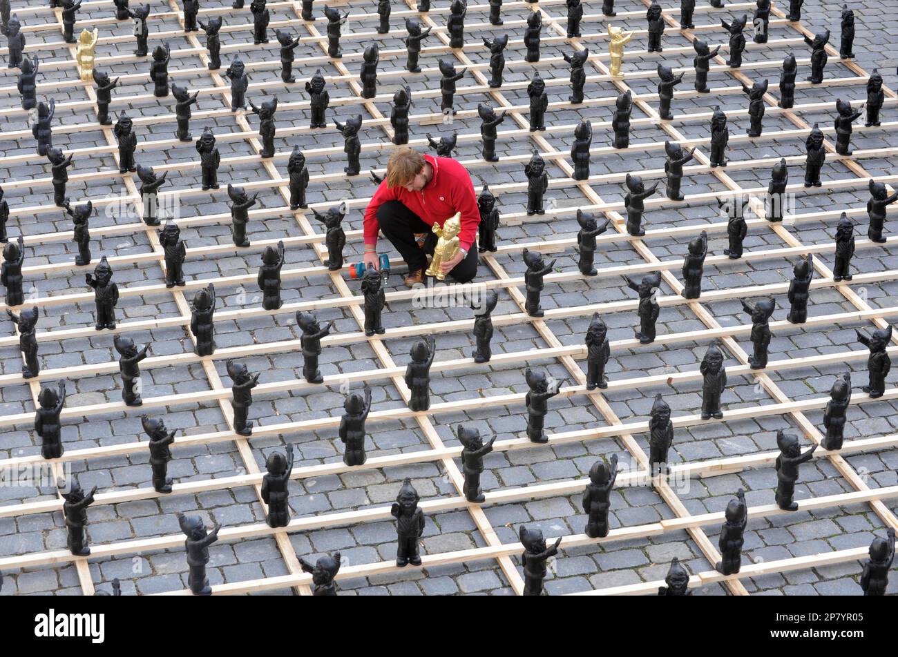 An assistent of the German artist Ottmar Hoerl positions a gnomes which ...