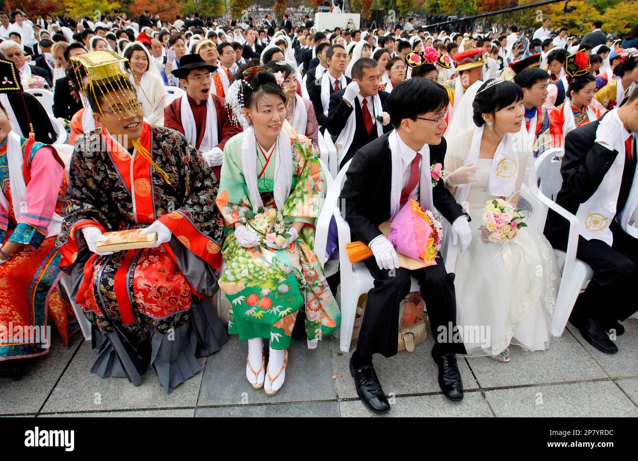 Couples from around the world participate in a mass wedding ceremony ...
