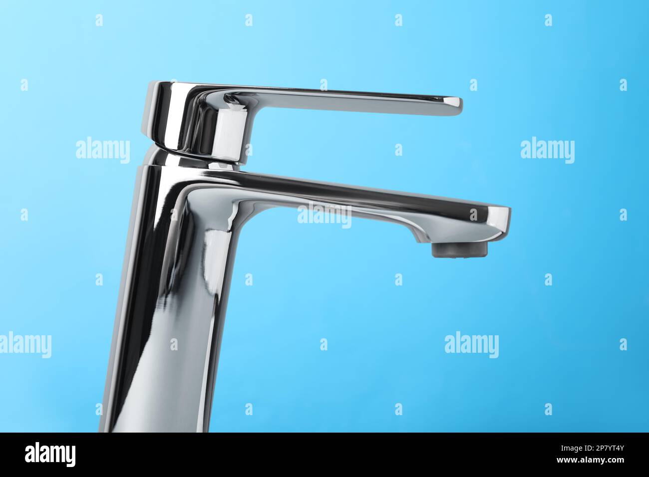 Single handle water tap on light blue background, closeup Stock Photo ...