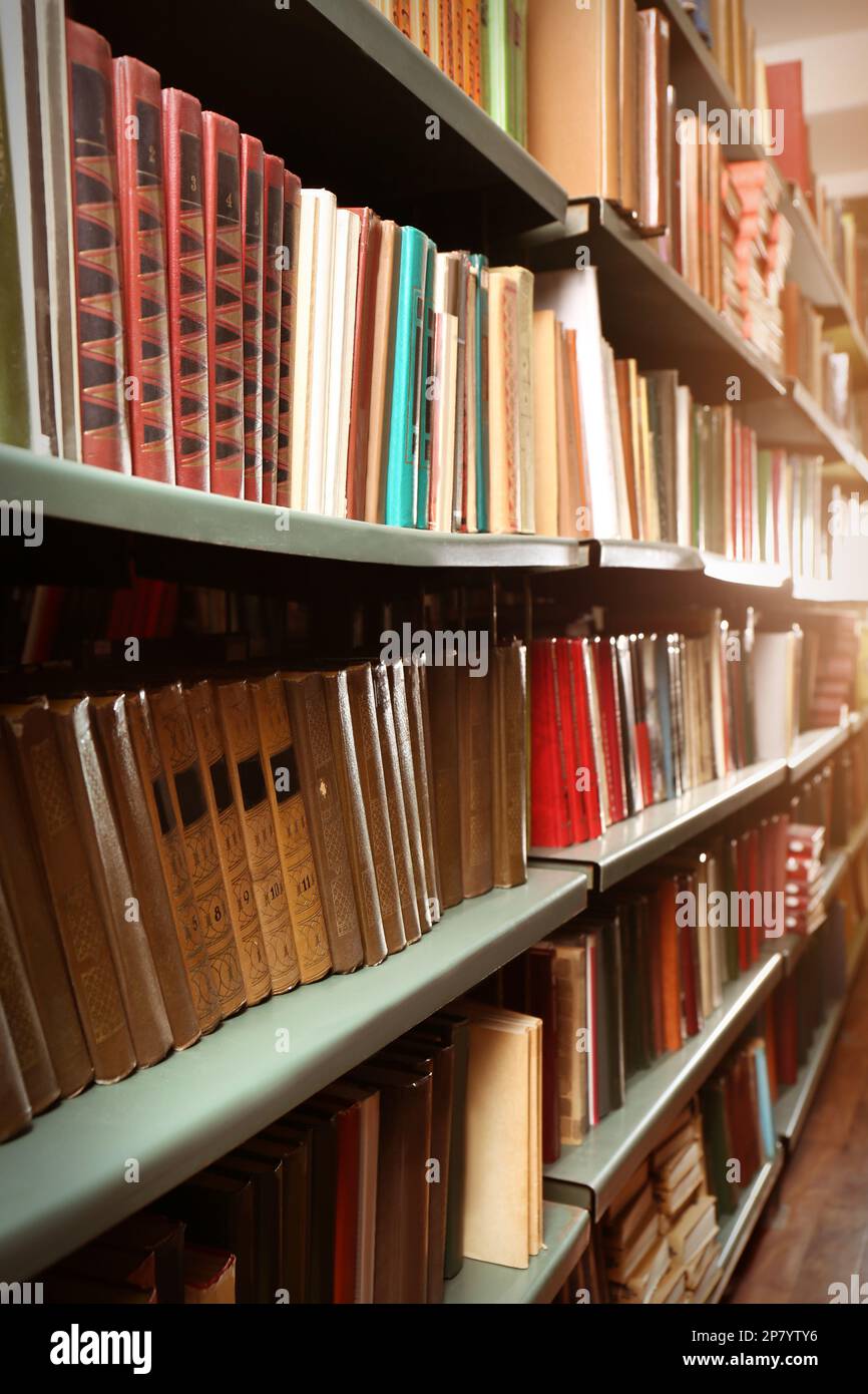 Collection of different books on shelves in library Stock Photo - Alamy