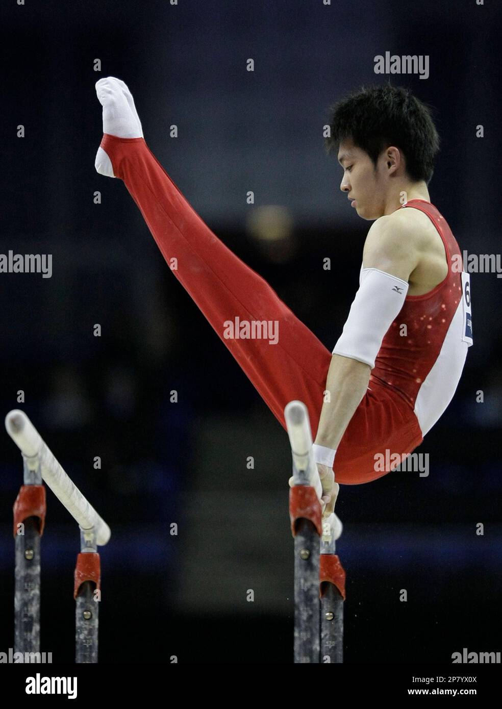 Japan's Kazuhito Tanaka in action on the parallel bars during men's ...
