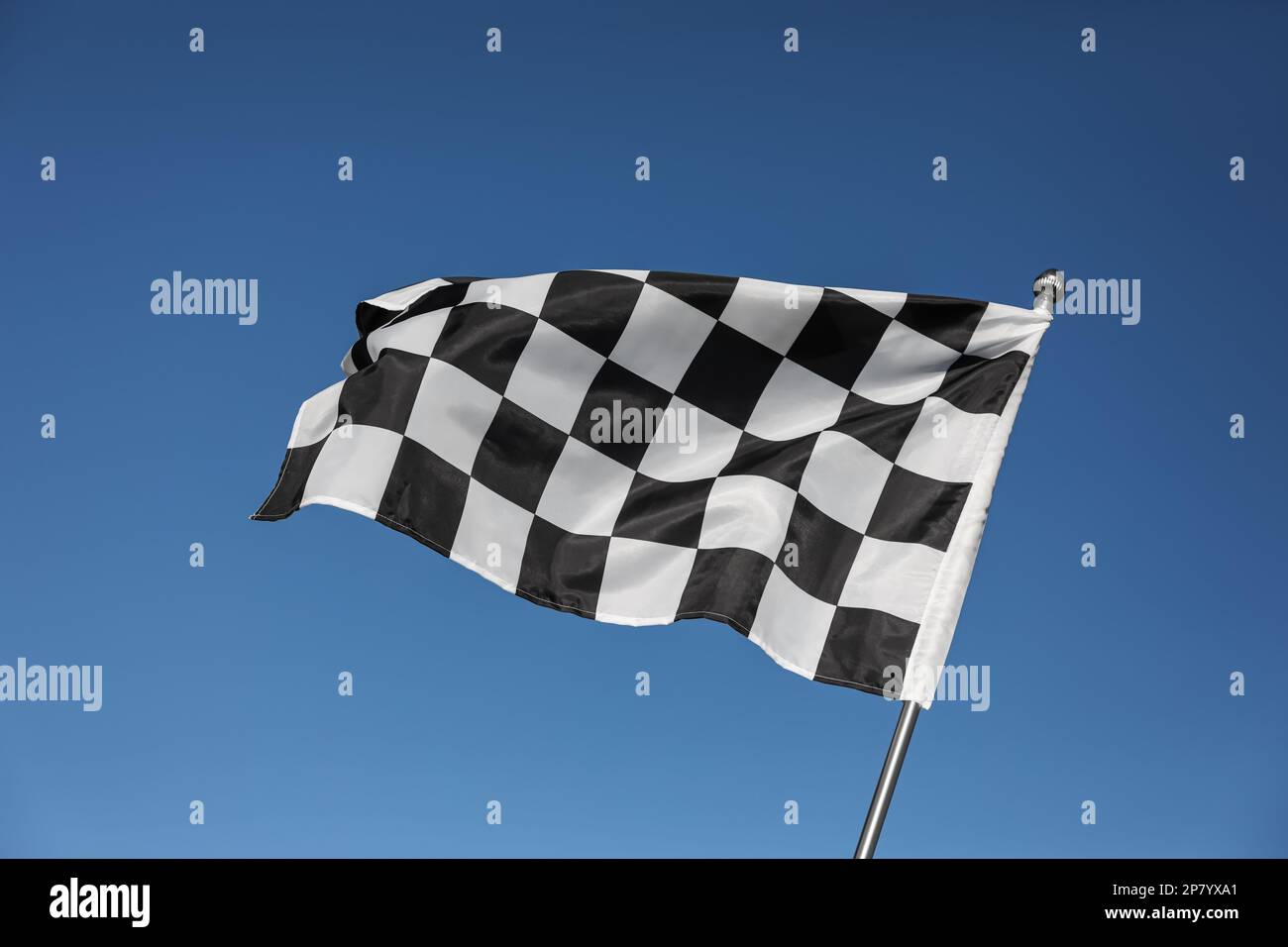 Checkered finish flag on light blue background Stock Photo - Alamy