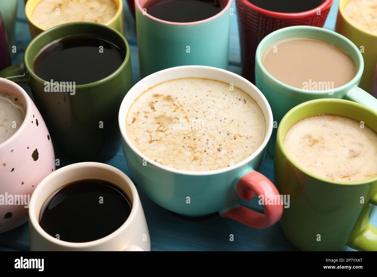 Many cups of different coffee drinks on light blue table Stock Photo ...